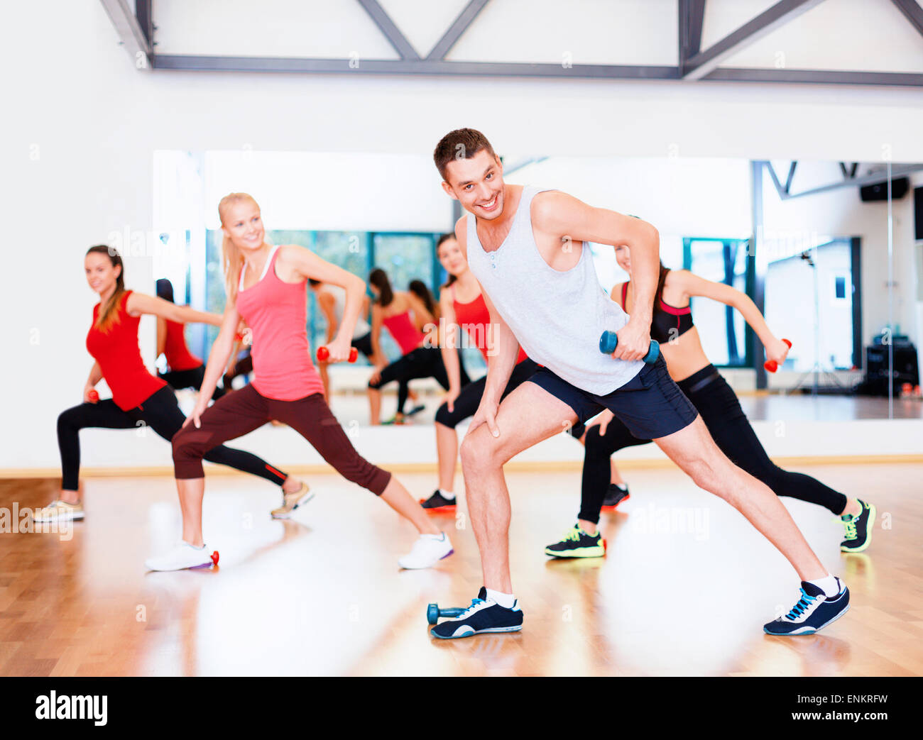 group of smiling people working out with dumbbells Stock Photo - Alamy