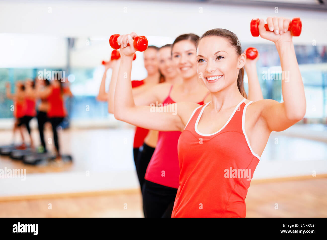 group of smiling people working out with dumbbells Stock Photo - Alamy