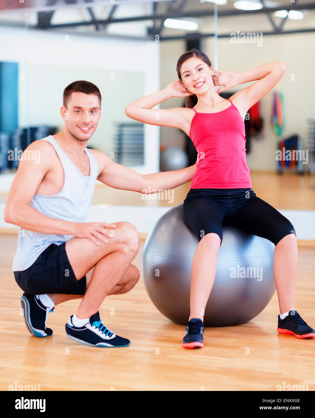 male trainer with woman doing crunches on the ball Stock Photo - Alamy