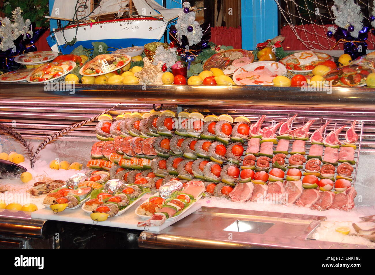A display of meat and seafood in a shop window in Paris Stock Photo - Alamy