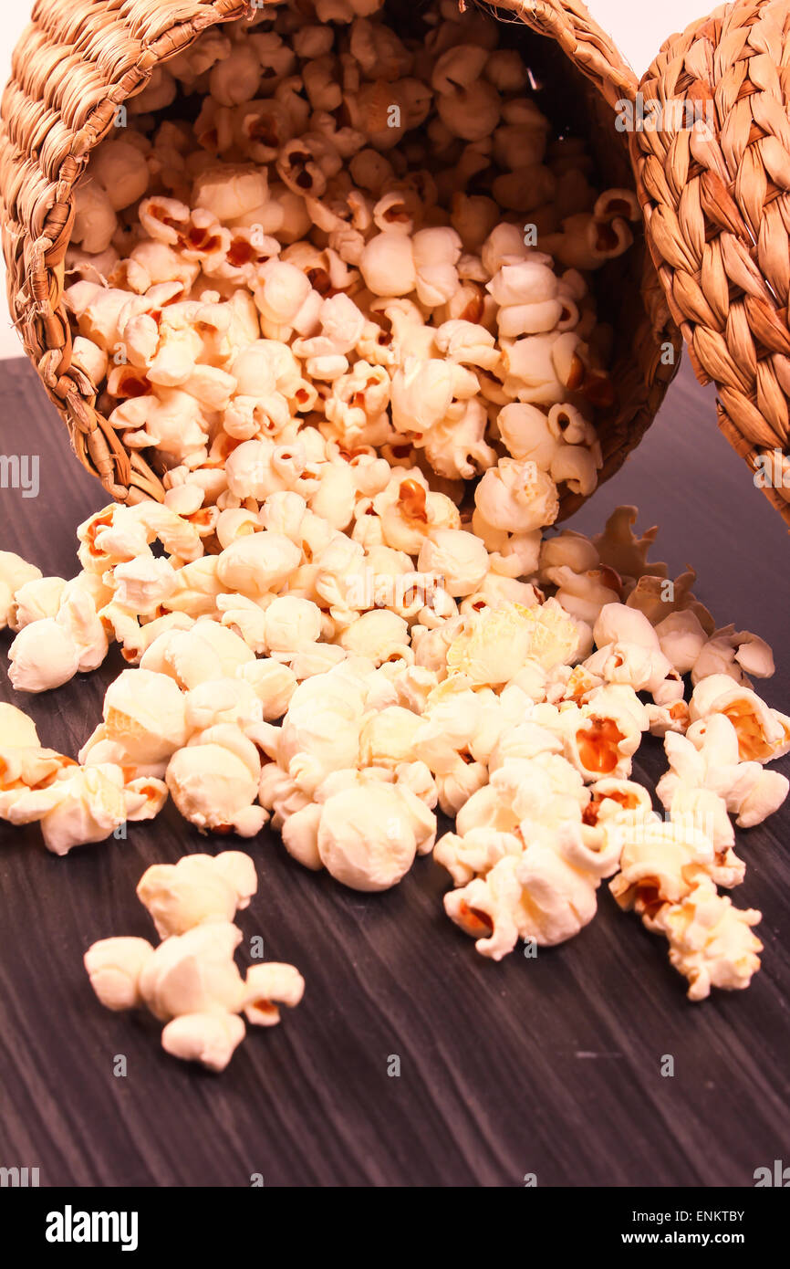 popcorn in bowl spreading on wooden block Stock Photo - Alamy