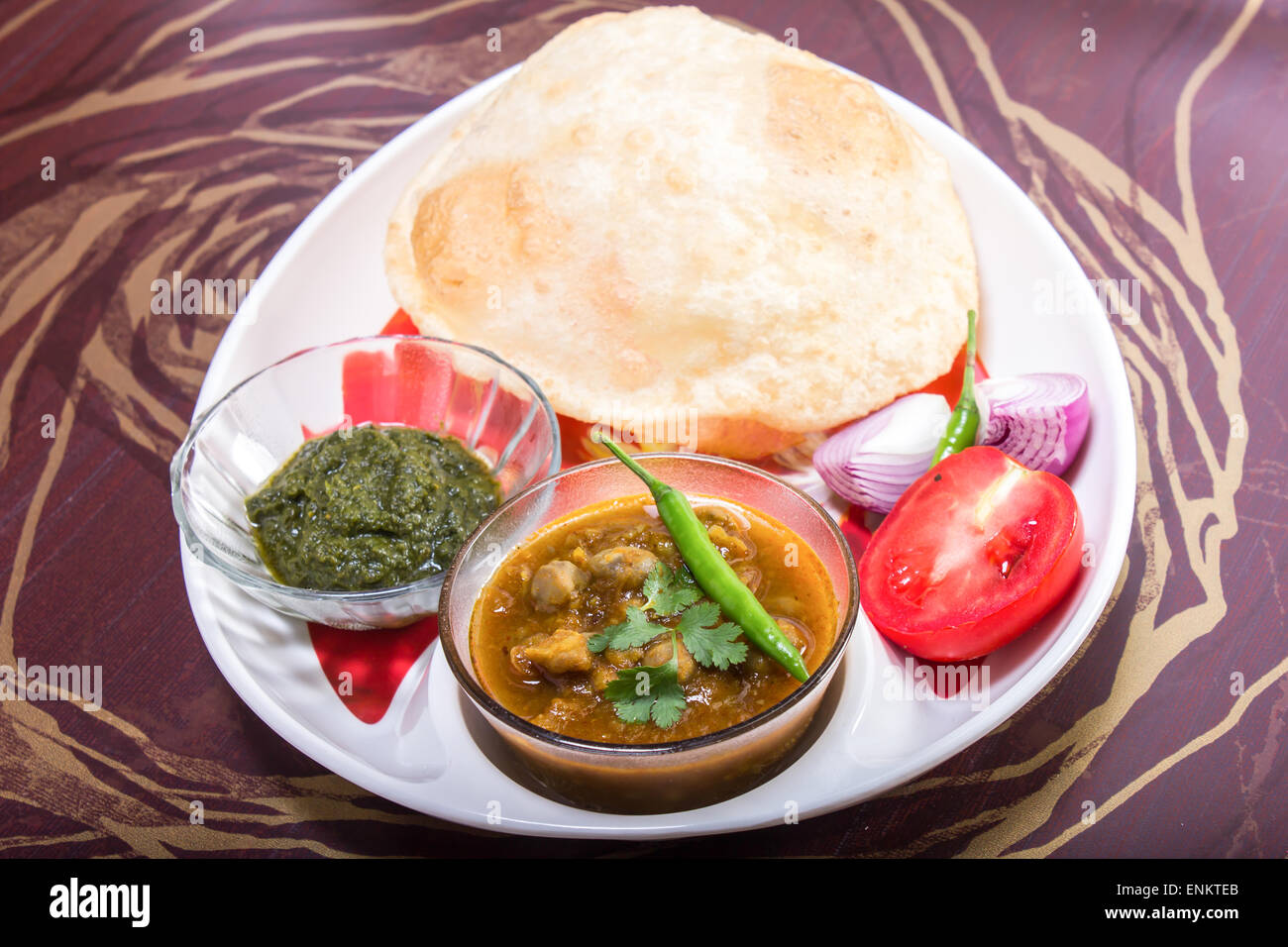 spicy chole bhautre, with green chili topping, indian dish Stock Photo ...