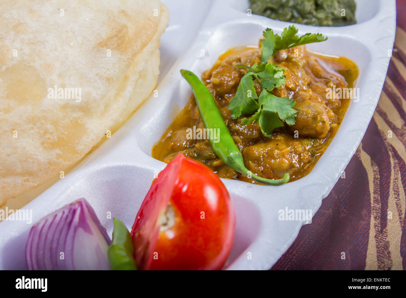 spicy chole bhautre, with green chili topping, and salad, indian dish ...