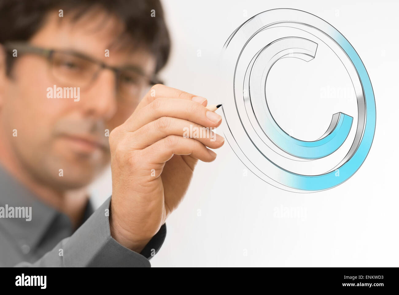 Creative man drawing copyright symbol on a transparent wall ...
