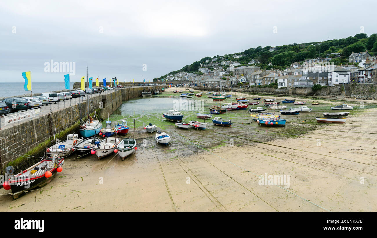 Cornish fishing village of Mousehole with its pretty harbour at low ...