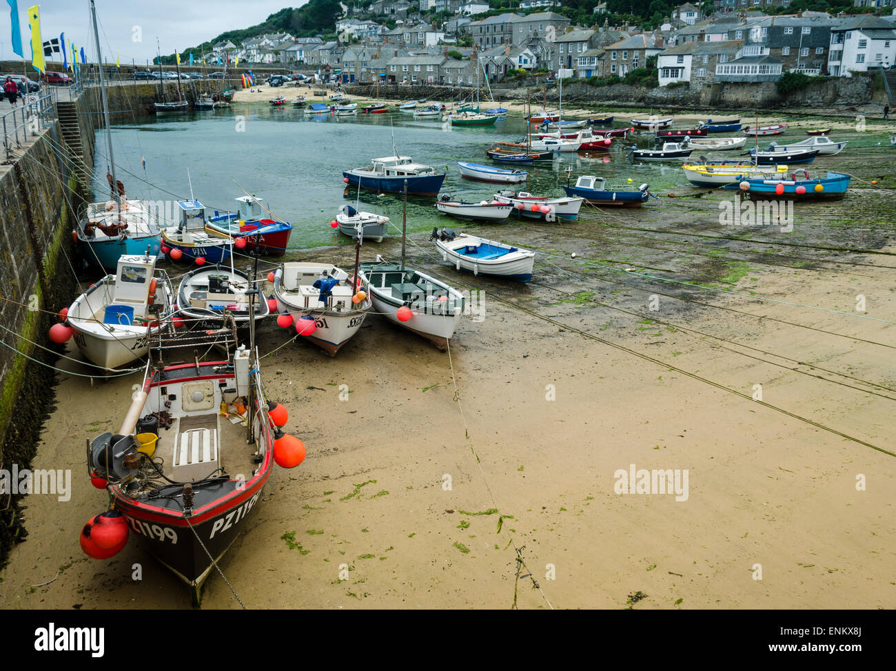 Cornish fishing village of Mousehole with its pretty harbour at low ...
