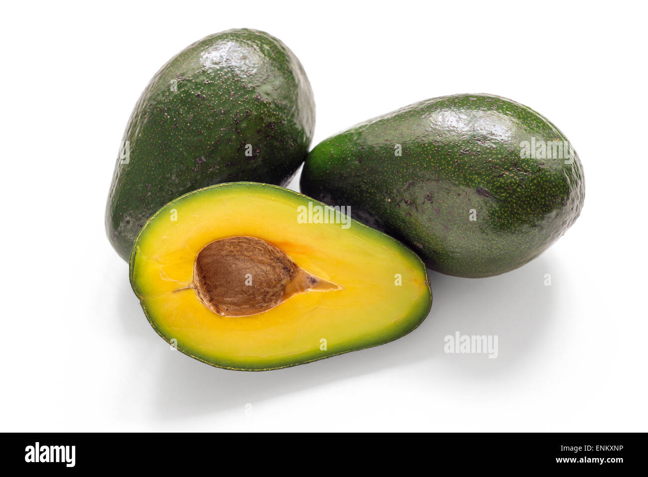 two whole and half avocados isolated on white Stock Photo - Alamy