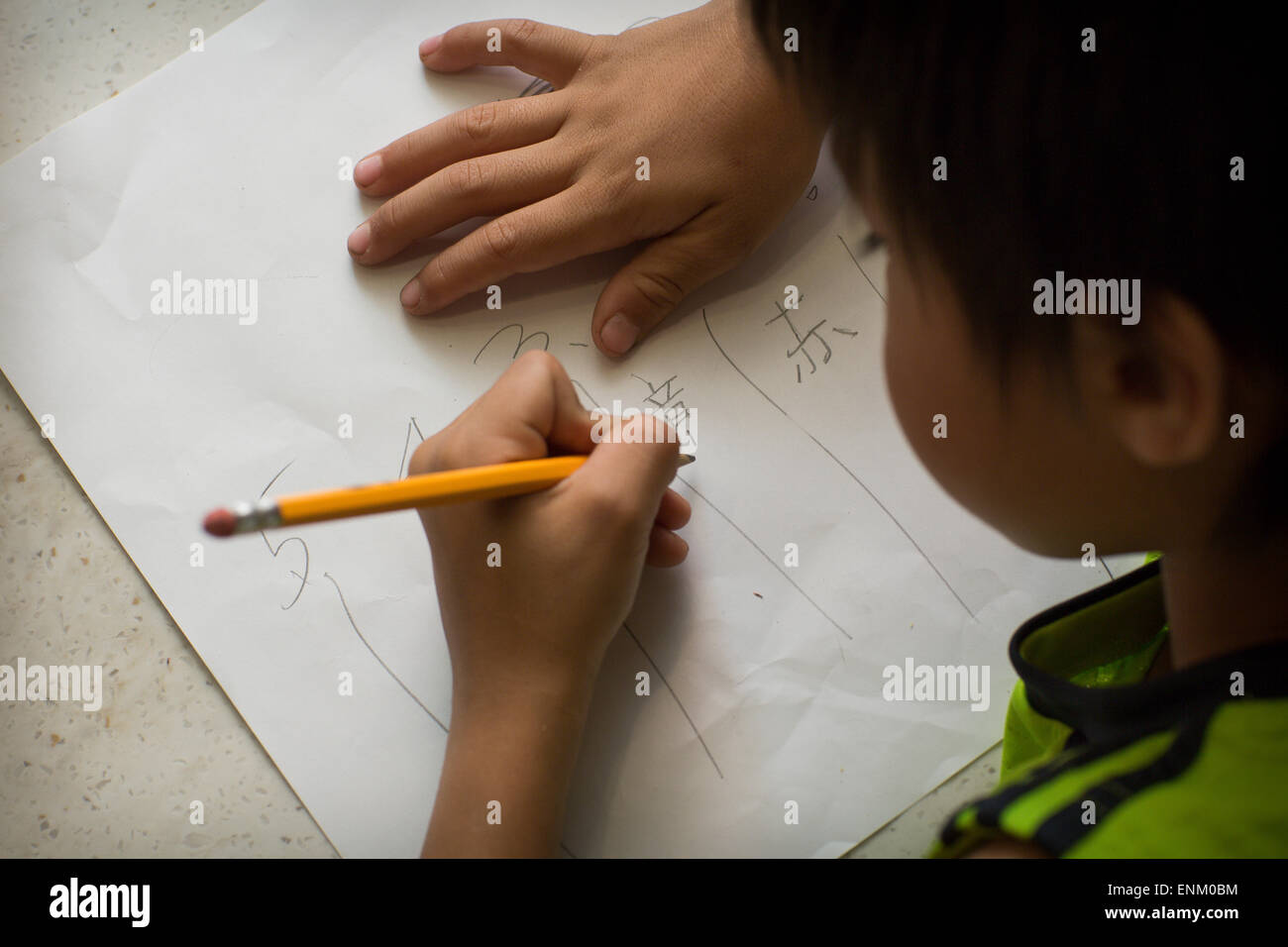 A Japanese boy studies Japanese homework in a kitchen Stock Photo - Alamy