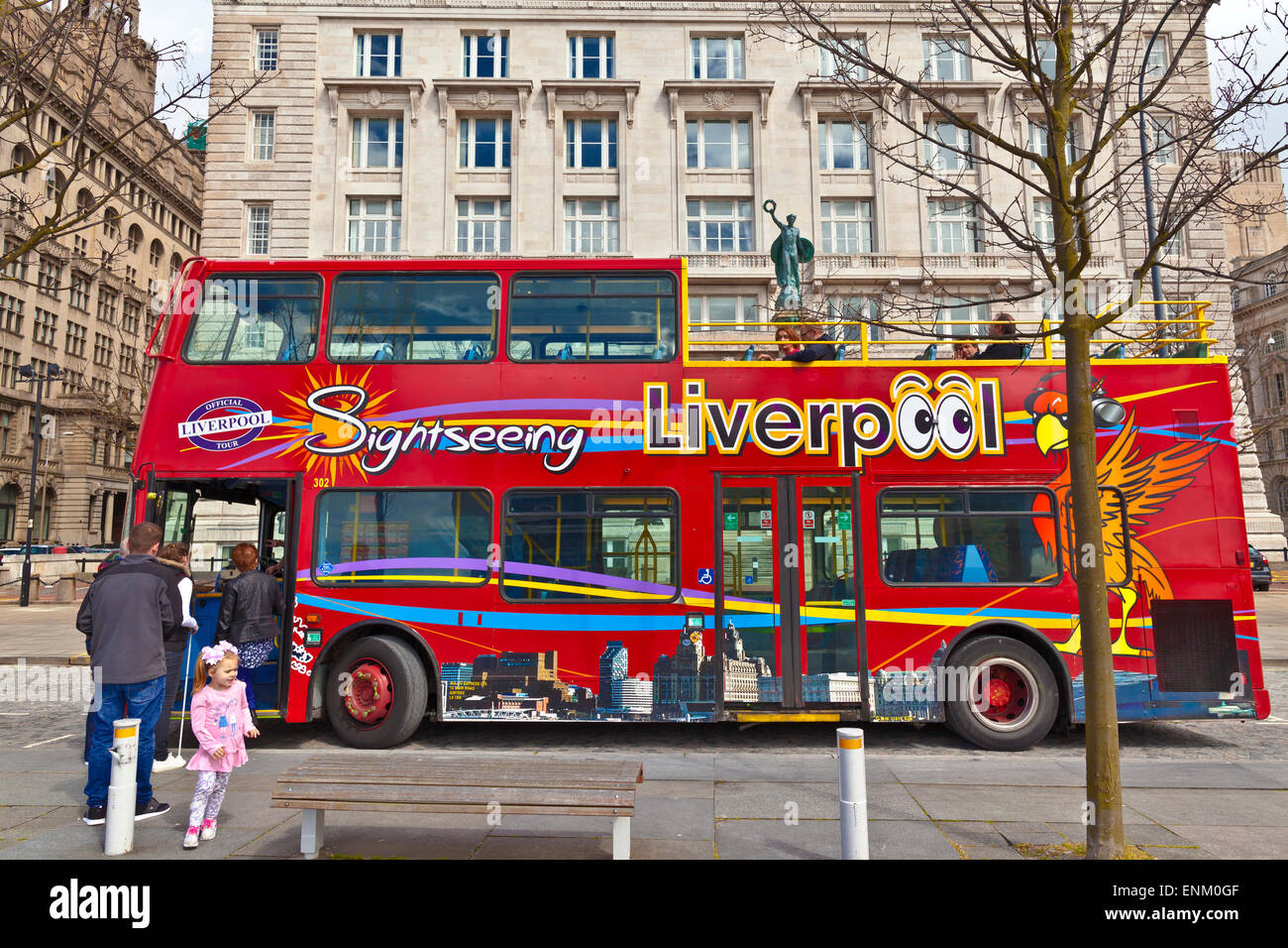 Sight seeing open top bus at the city centre decorated with images of ...