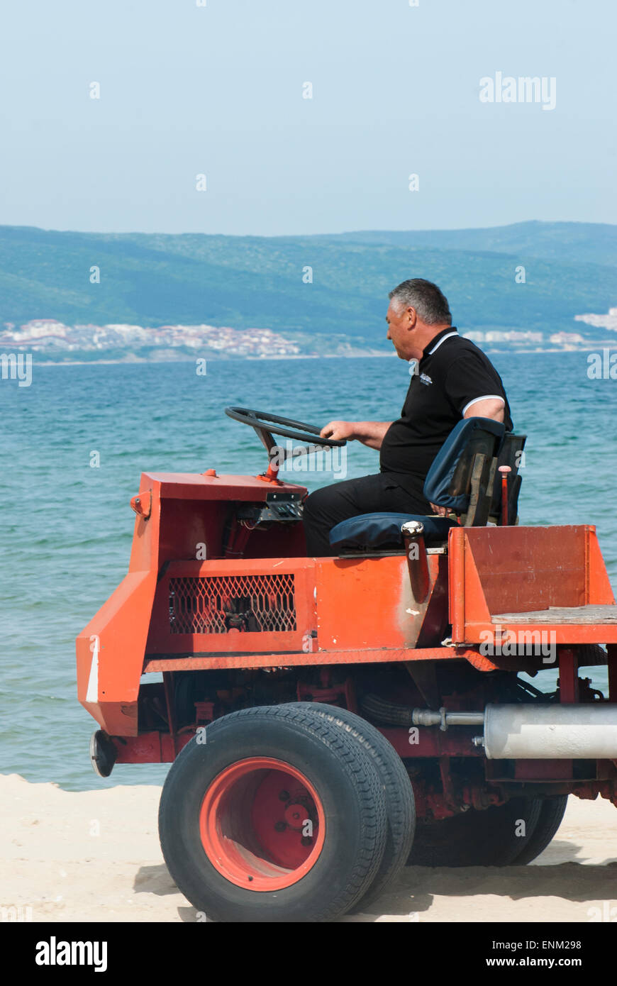 Grader on the beach Stock Photo - Alamy