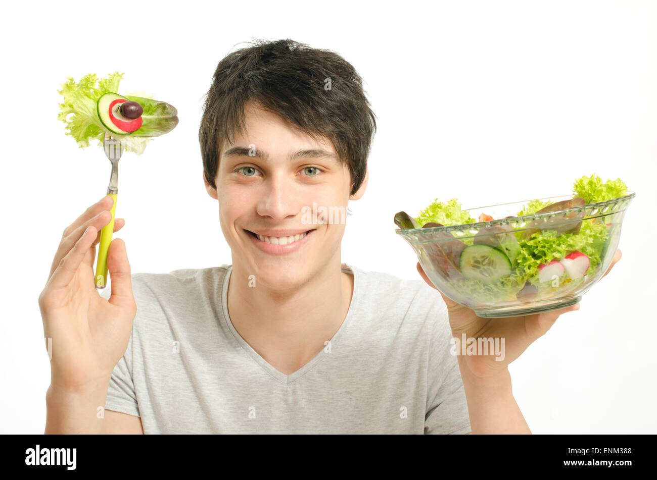 Man eating organic healthy salad for a perfect diet. Green food for a ...