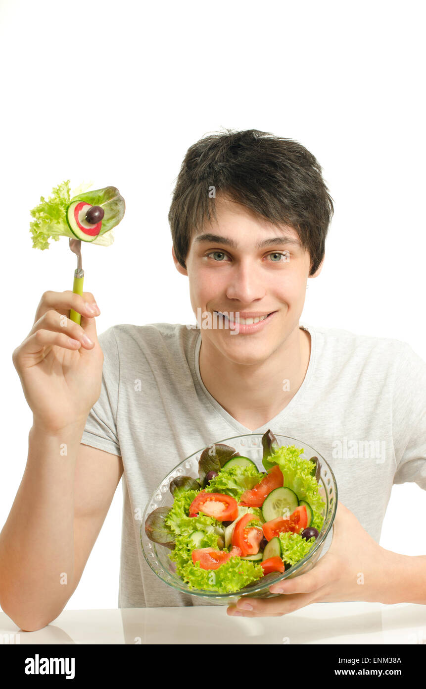 Man eating organic healthy salad for a perfect diet. Green food for a ...