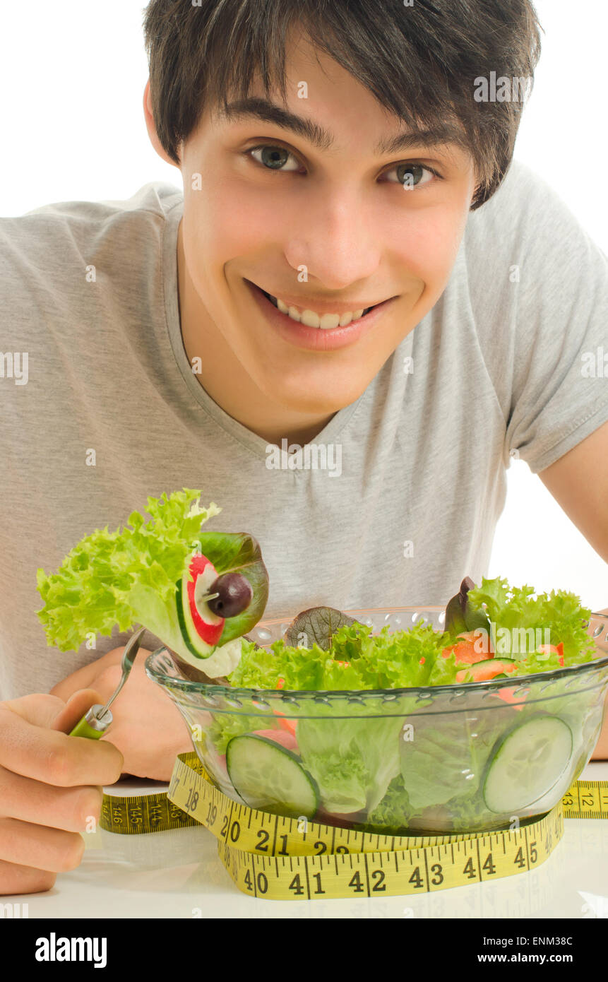 Man eating organic healthy salad for a perfect diet. Green food for a ...