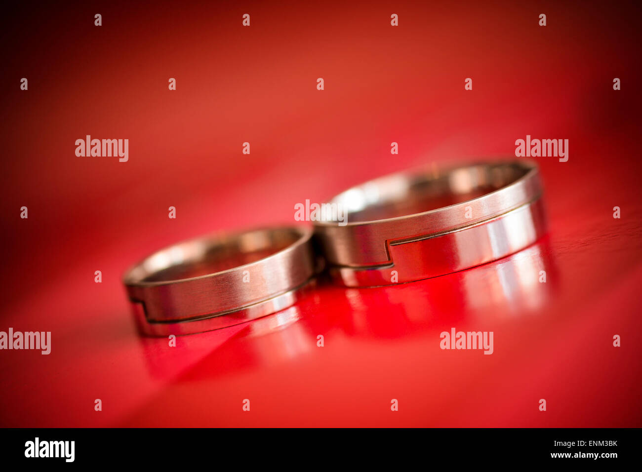 Isolated wedding rings with red background Stock Photo - Alamy