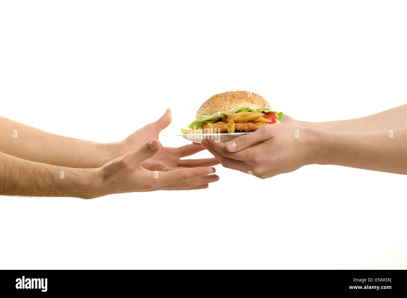 Hands offering a big hamburger and hungry hands ready to receive ...