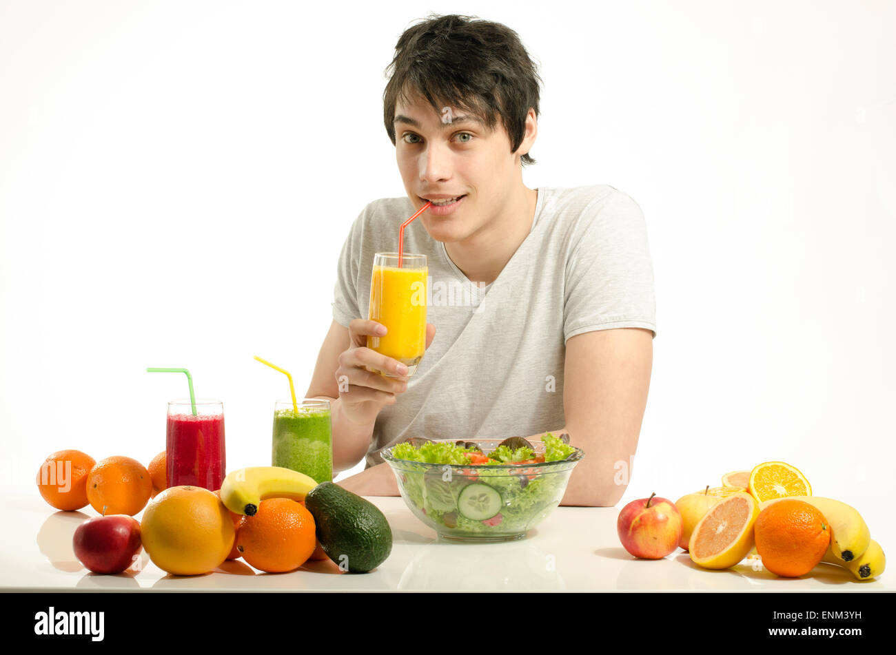 Man having a table full of organic food,juices and smoothie. Cheerful ...