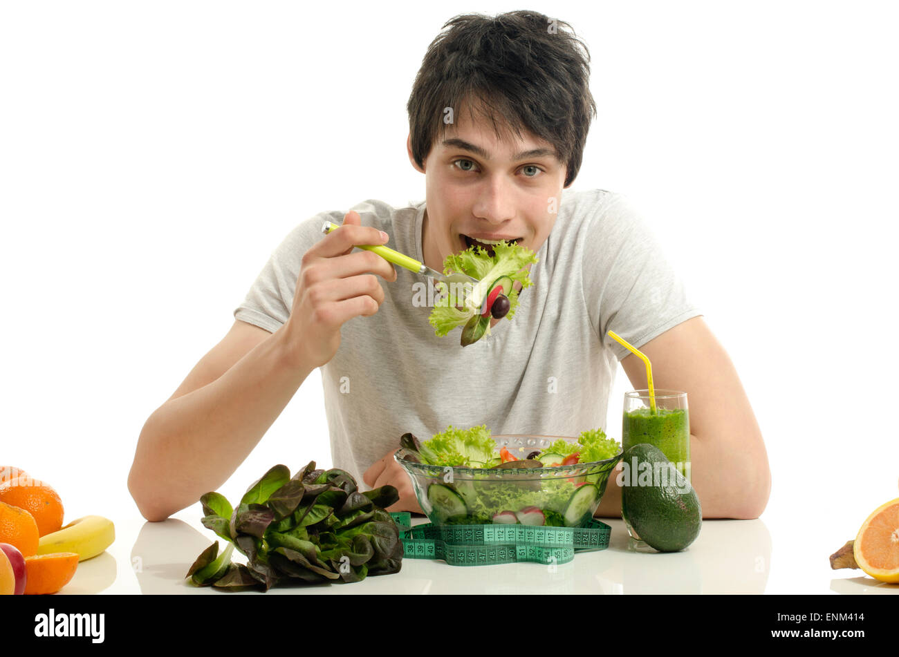 Man having a table full of organic food,juices and smoothie. Cheerful ...