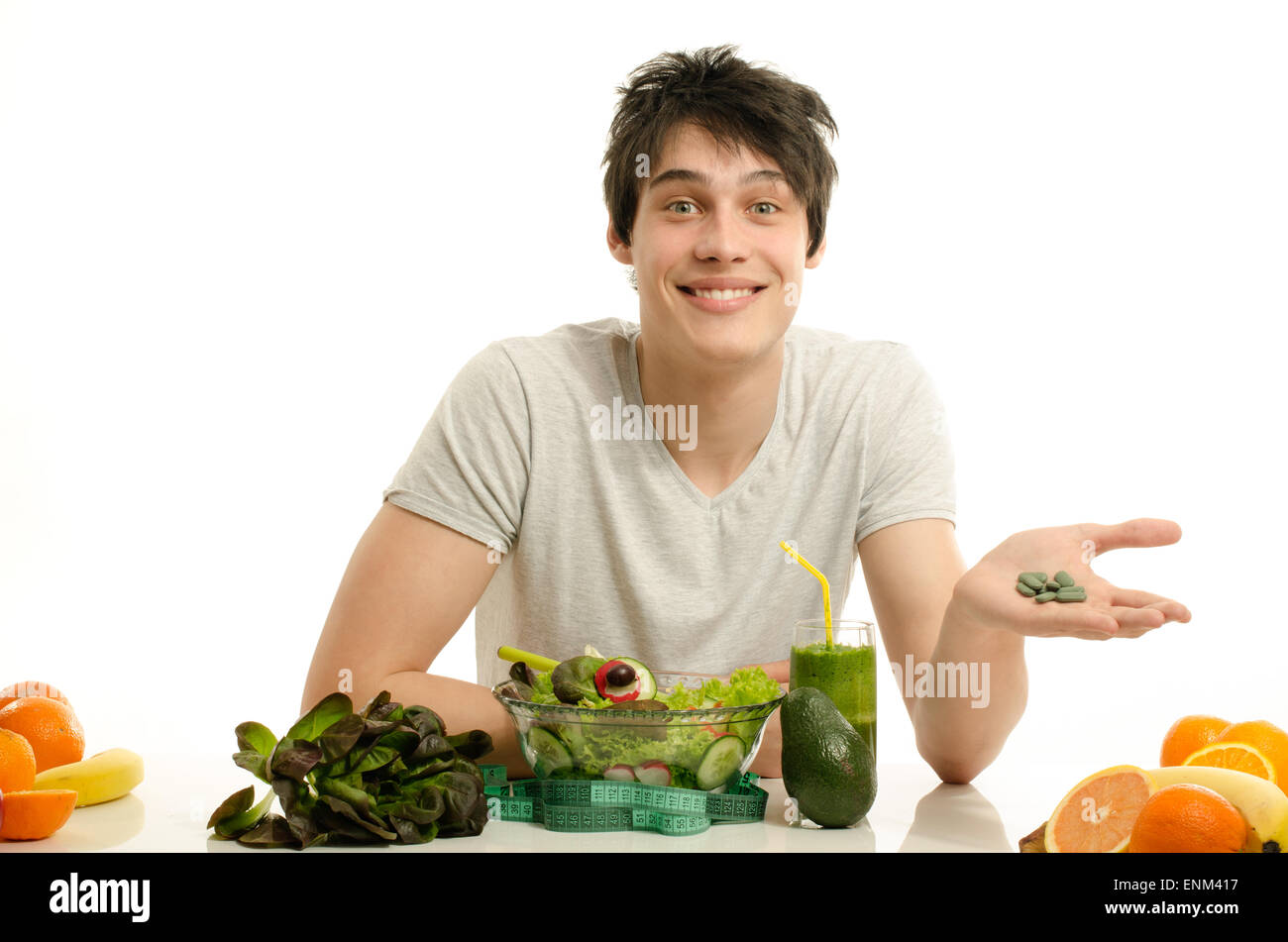 Man choosing between eating healthy organic food and pills. Happy man ...