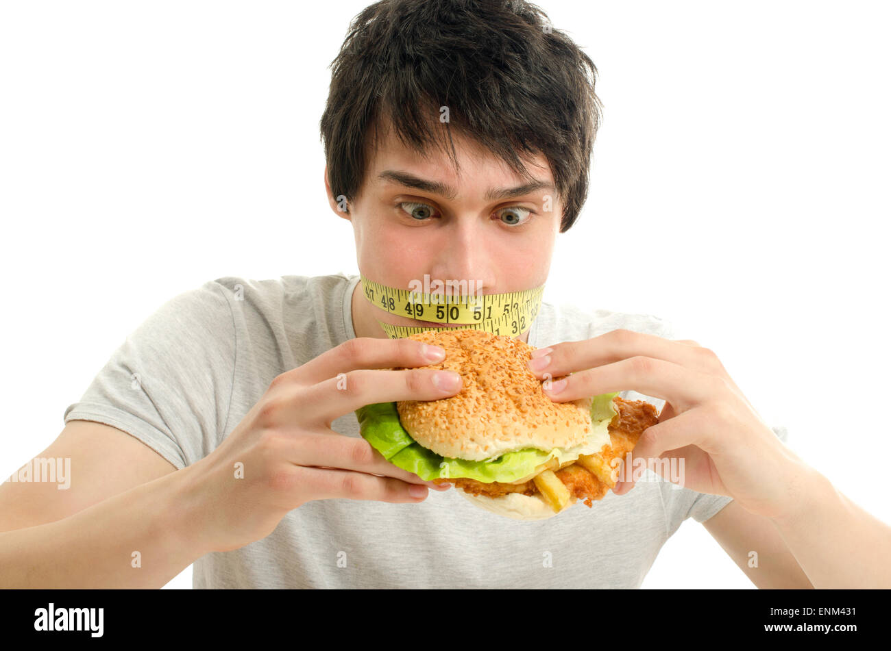Man with a centimeter on his mouth unable to eat a big hamburger, young ...