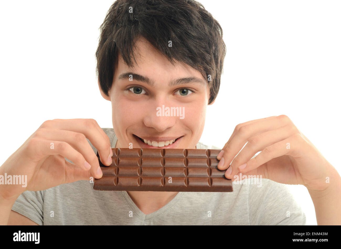 Happy man eating a yummy chocolate and having some sugar for an active ...