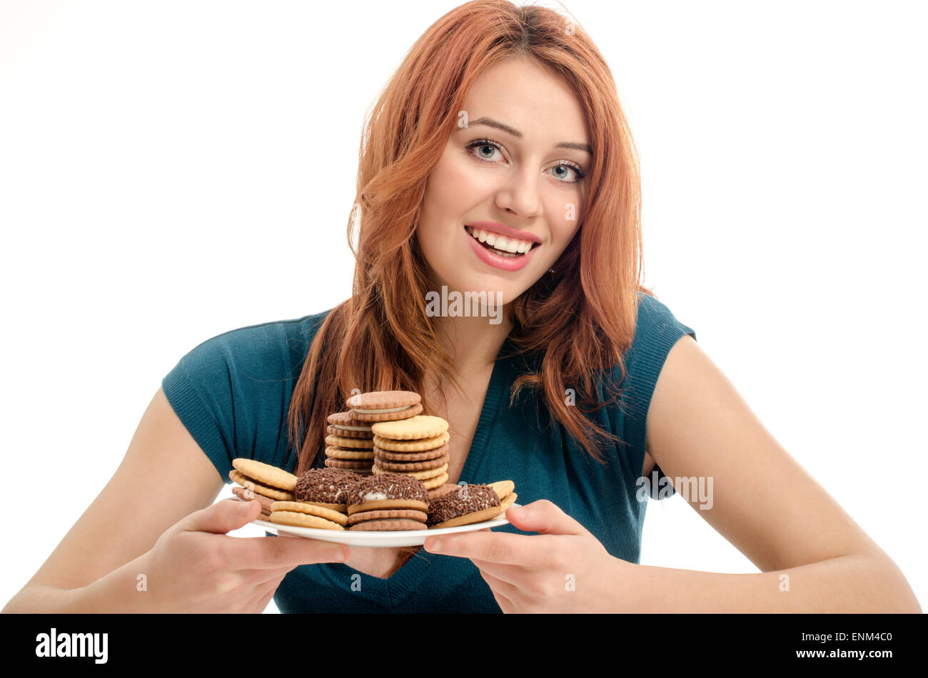 Girl having fun and eating lots of biscuits, muffins, fondants. Woman ...