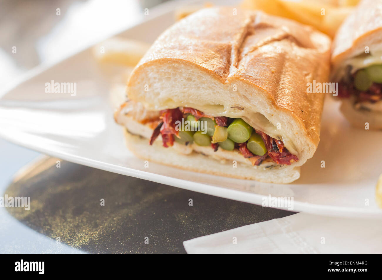 Healthy and filling grilled chicken and asparagus sandwich on a torpedo ...