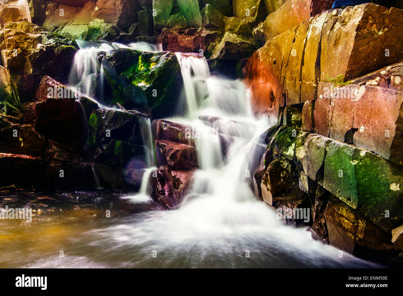 Beautiful waterfall and colorful stone Stock Photo - Alamy