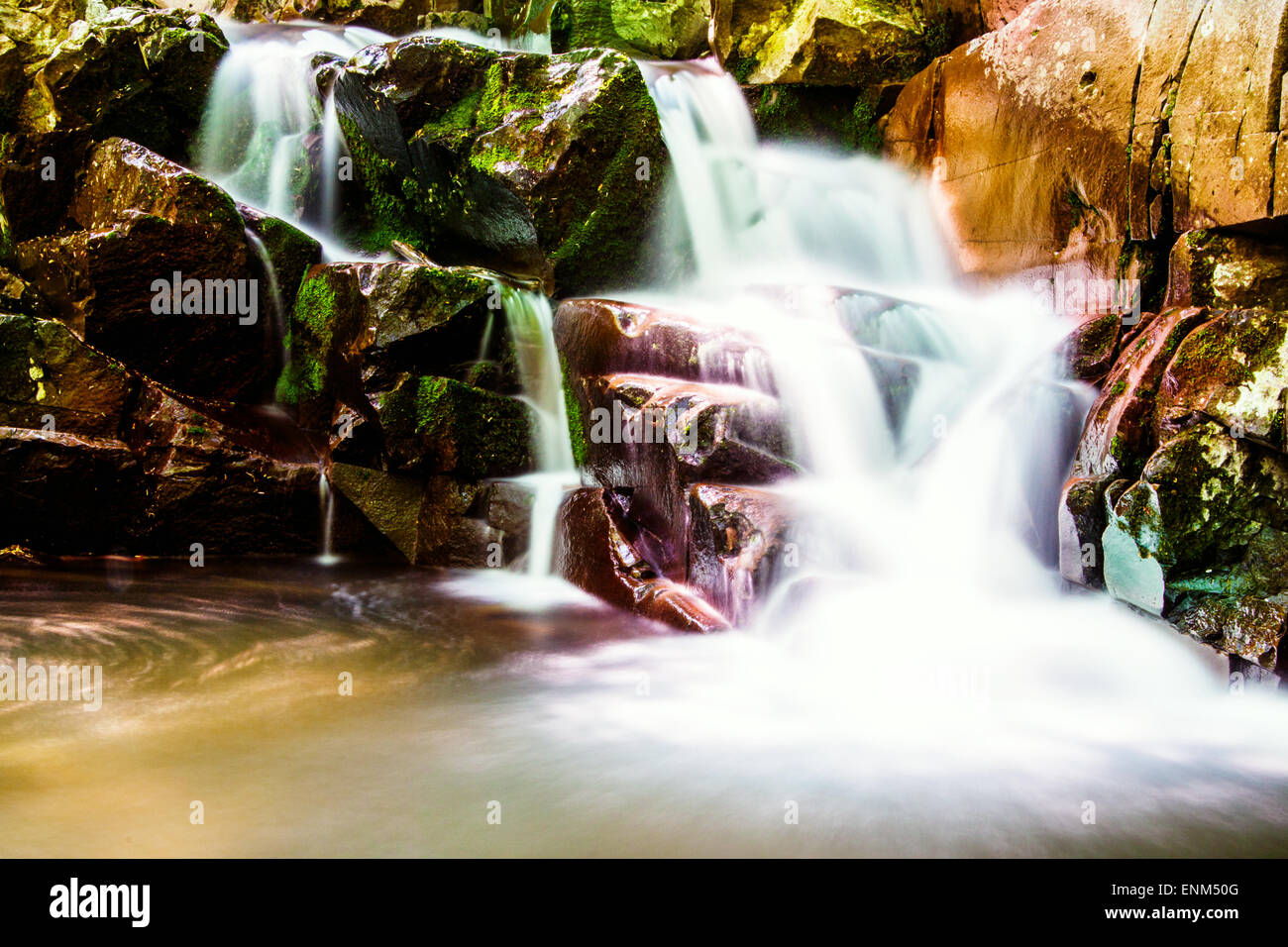 Beautiful waterfall and colorful stone Stock Photo - Alamy