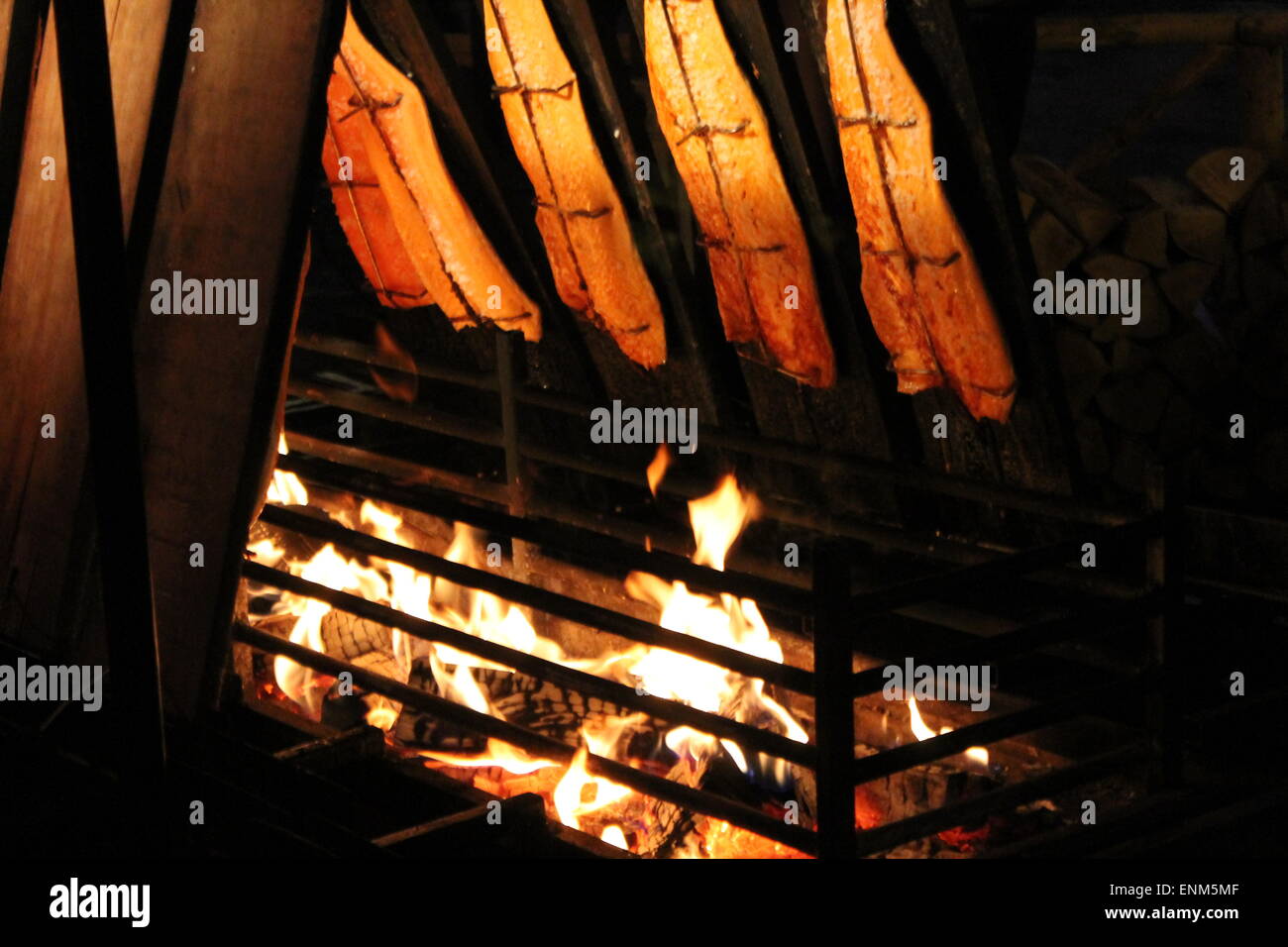 Salmon being smoked over an open wood fire Stock Photo - Alamy