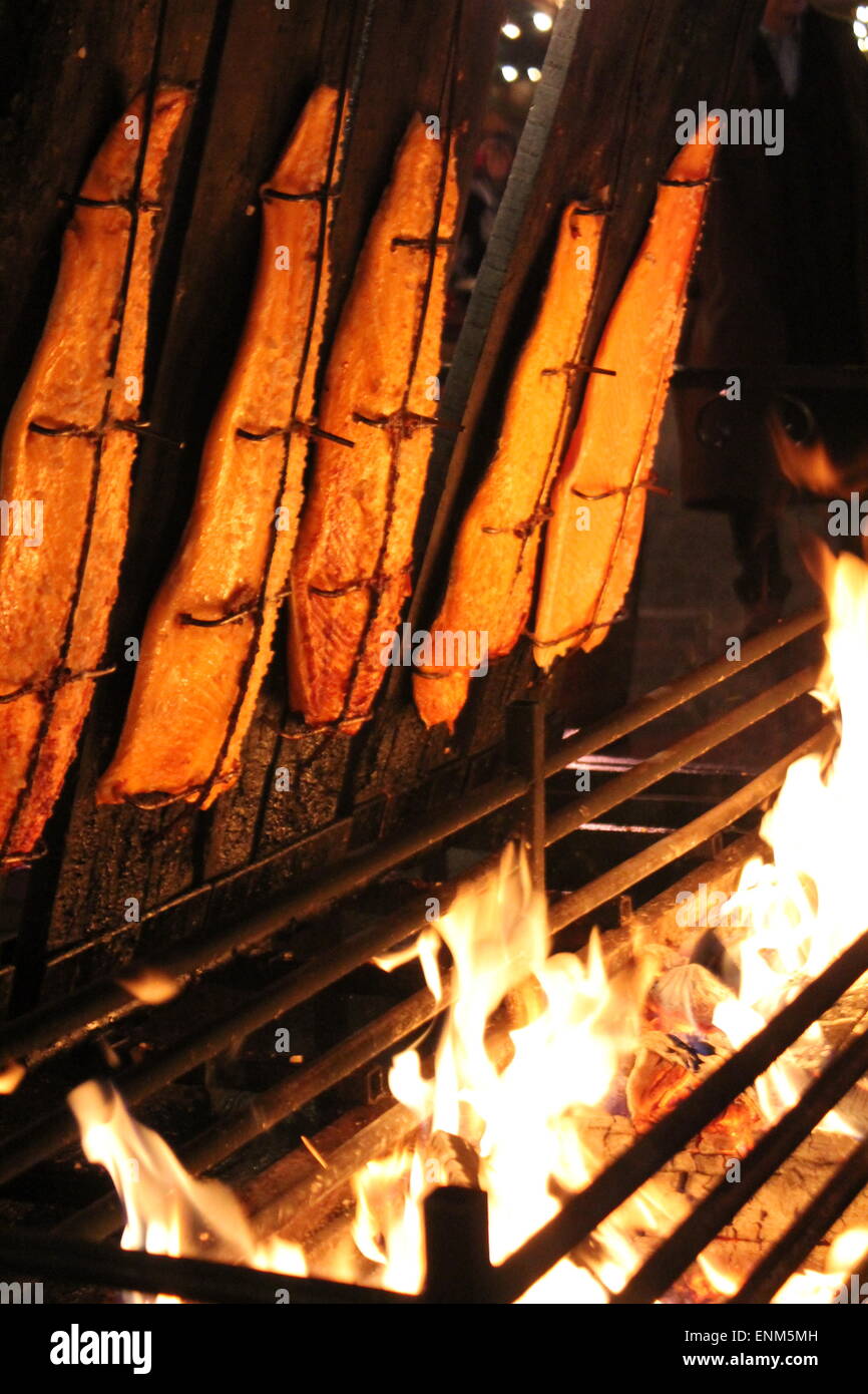 Salmon being smoked over an open wood fire Stock Photo - Alamy