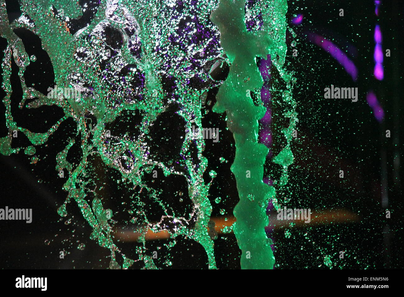 Fountain water splashing by lights at night Stock Photo - Alamy
