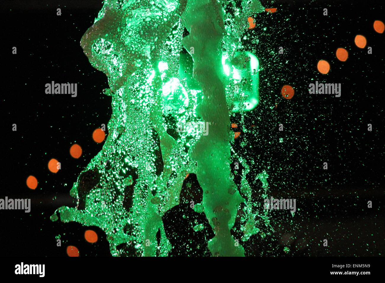 Fountain water splashing by lights at night Stock Photo - Alamy