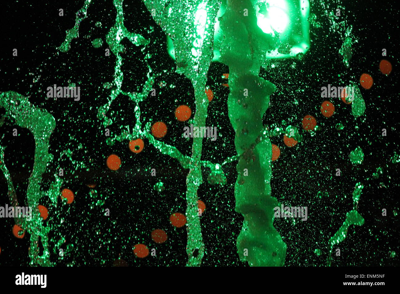 Fountain water splashing by lights at night Stock Photo - Alamy