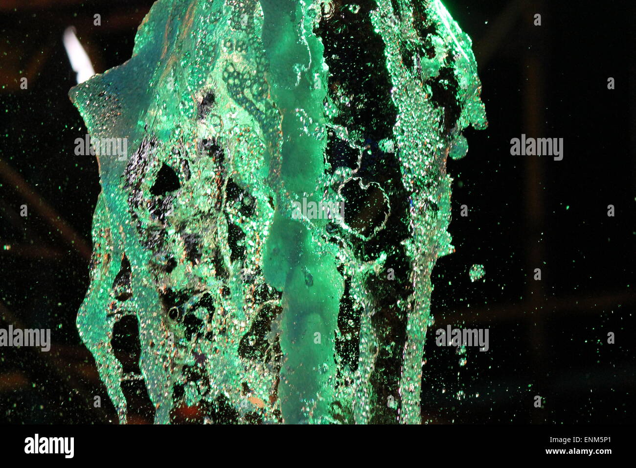 Fountain water splashing by lights at night Stock Photo - Alamy