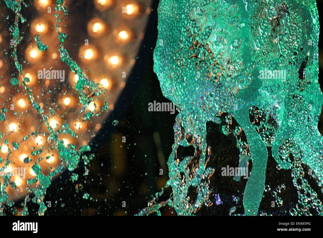 Fountain water splashing by lights at night Stock Photo - Alamy