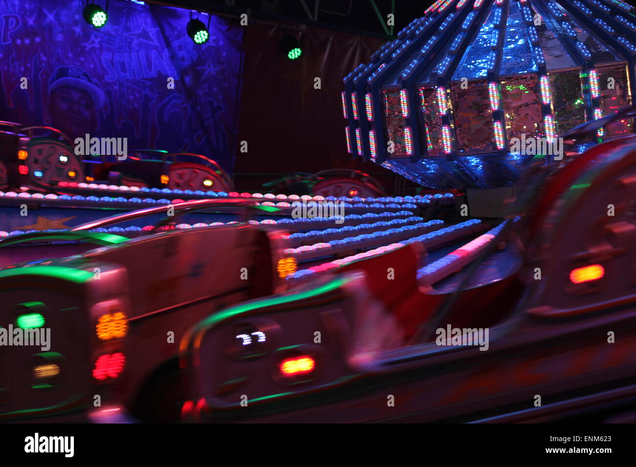 fairground funfair ride moving fast fair lights Night colours of the ...