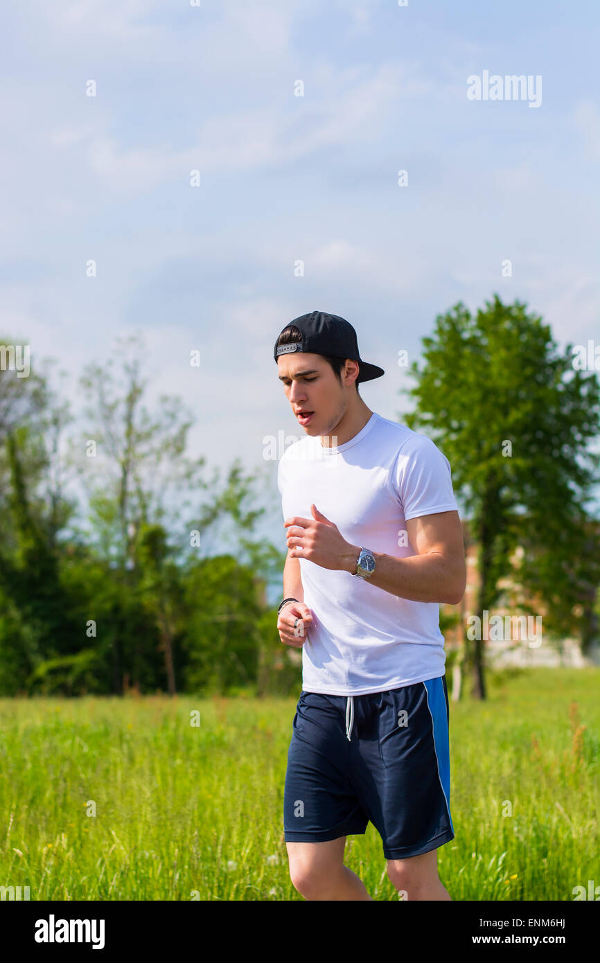Young man running and jogging on road in country Stock Photo - Alamy