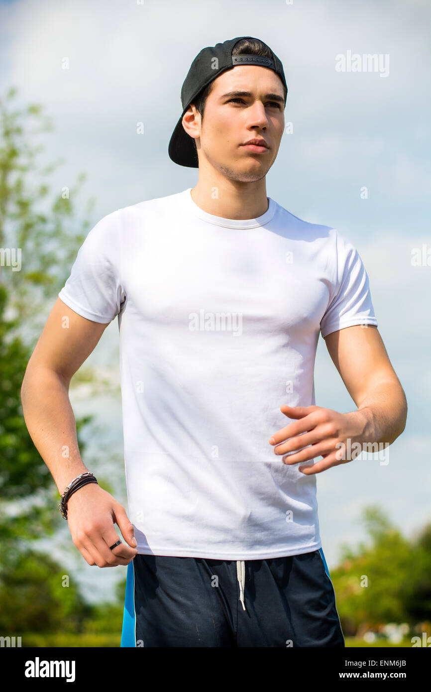 Young man running and jogging on road in country Stock Photo - Alamy