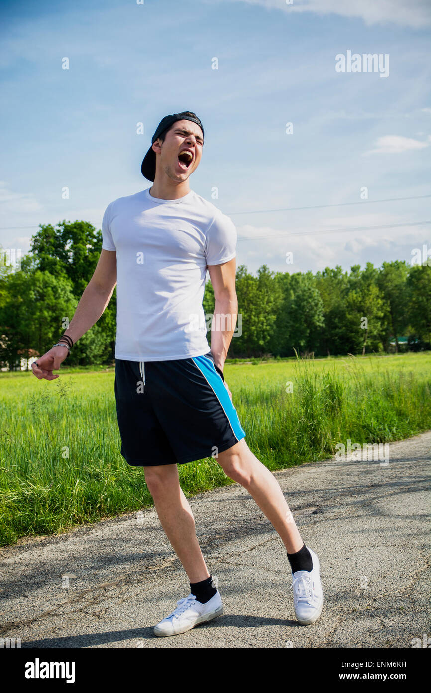 Handsome young man injured while running and jogging on road Stock ...