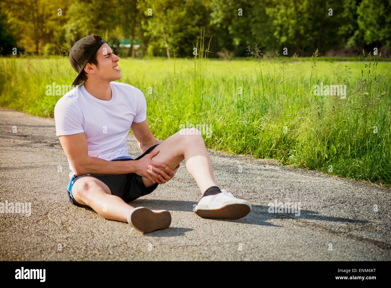 Handsome young man injured while running and jogging on road Stock ...