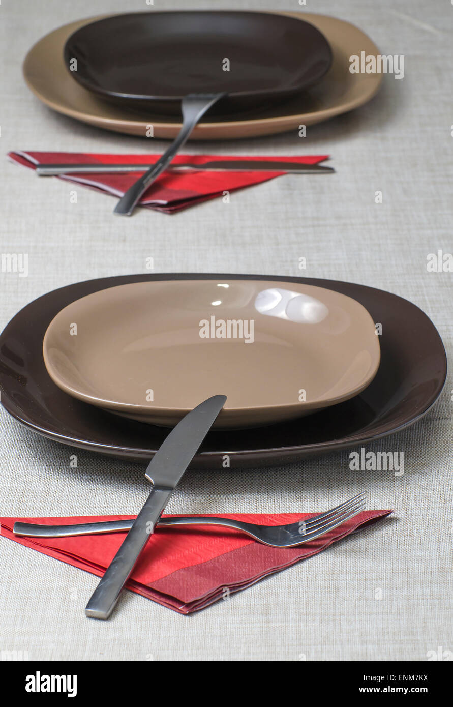 Dining table with cutlery and dishes Stock Photo - Alamy
