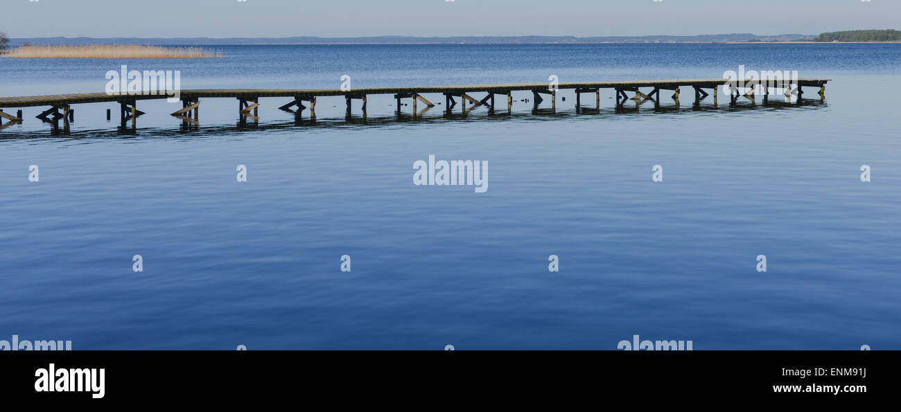 Landscape with jetty on small lake Stock Photo - Alamy