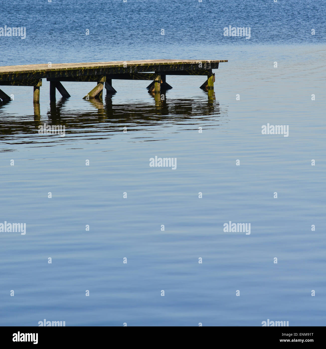 Landscape with jetty on small lake Stock Photo - Alamy