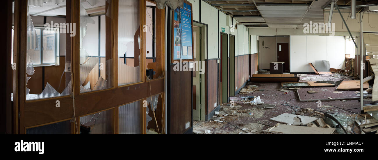 A disused old abandoned derelict office full of smashed glass and ...