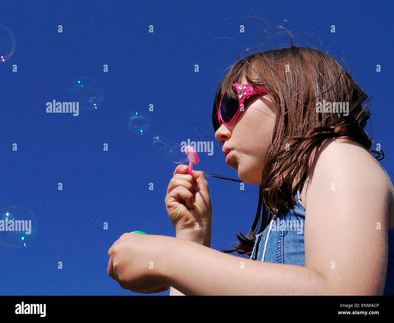 Child blowing bubbles Stock Photo - Alamy