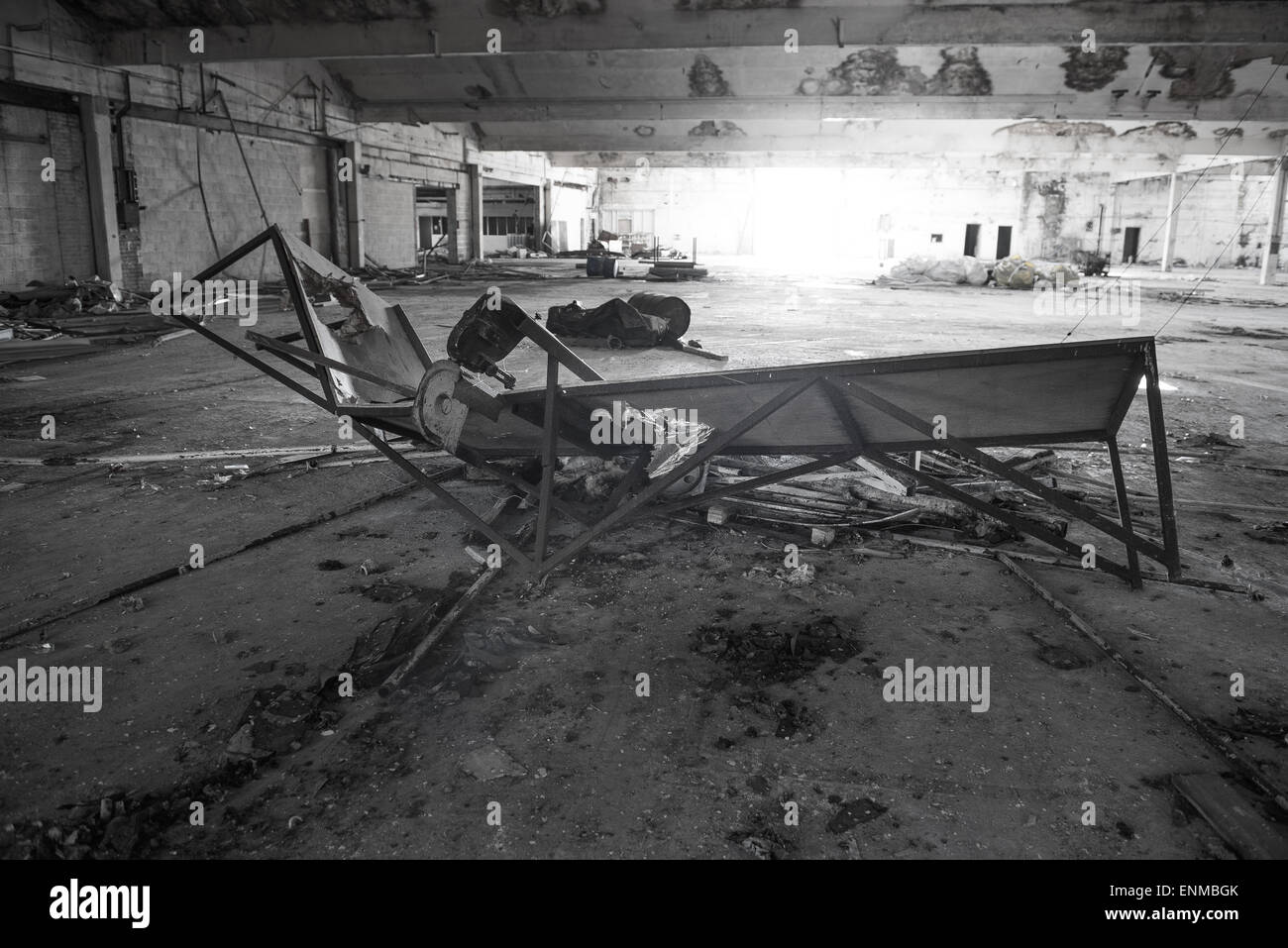 Black and white wide angle shot in a disused warehouse of a smashed ...