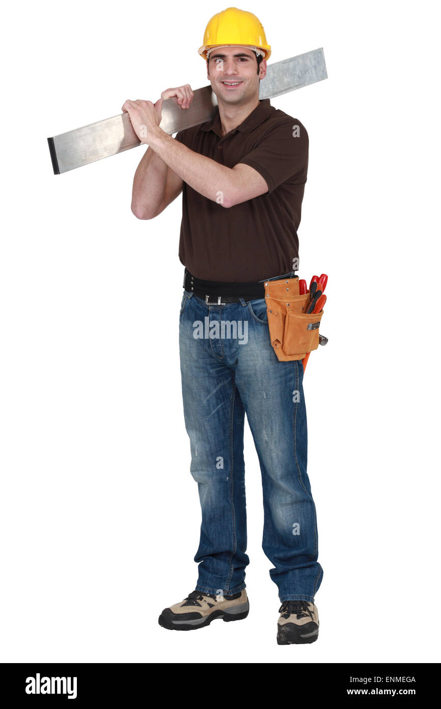 Builder carrying sheet of metal Stock Photo - Alamy