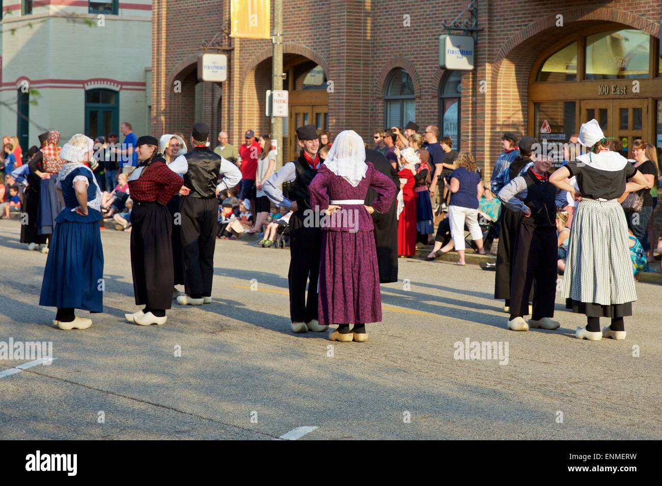 Dancers in traditional Dutch attire face each other as they begin ...