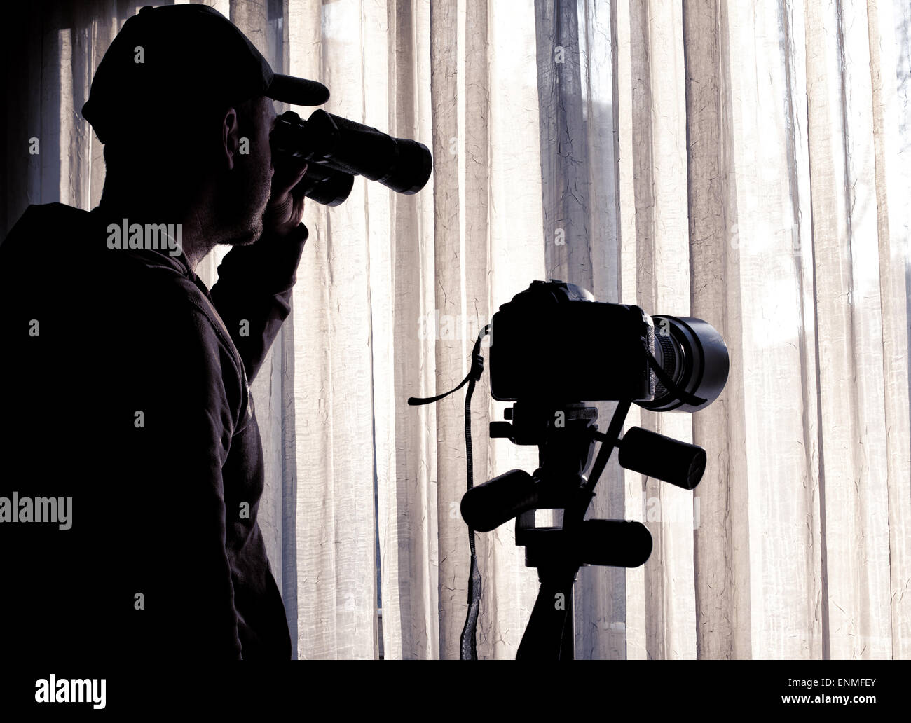 man with binoculars and camera control someone Stock Photo - Alamy