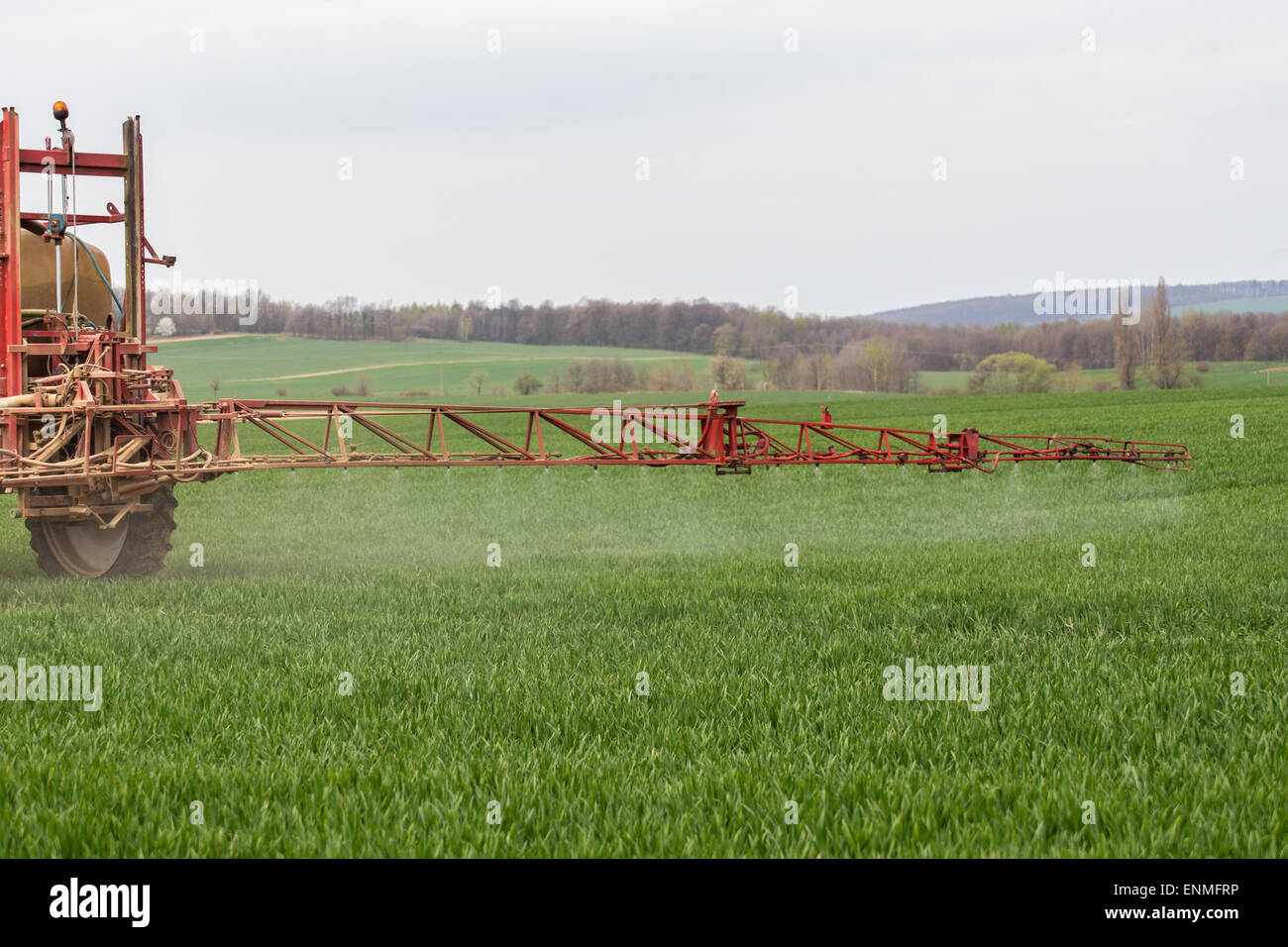 Spraying the herbicides on the green field Stock Photo - Alamy
